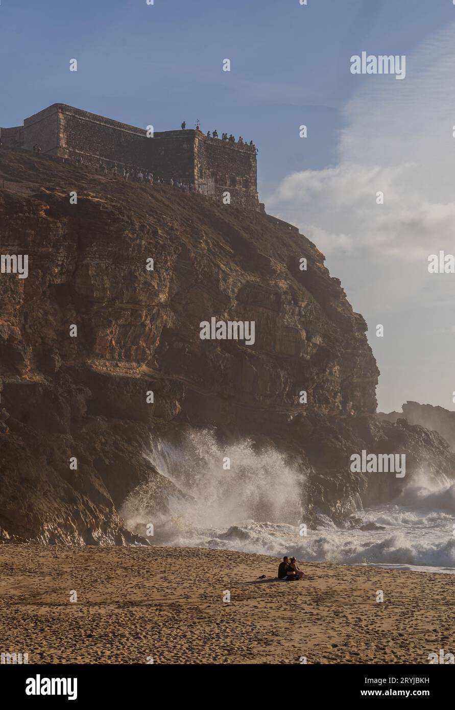 View of windy surfing north beach, fort and lighthouse in Nazare ...