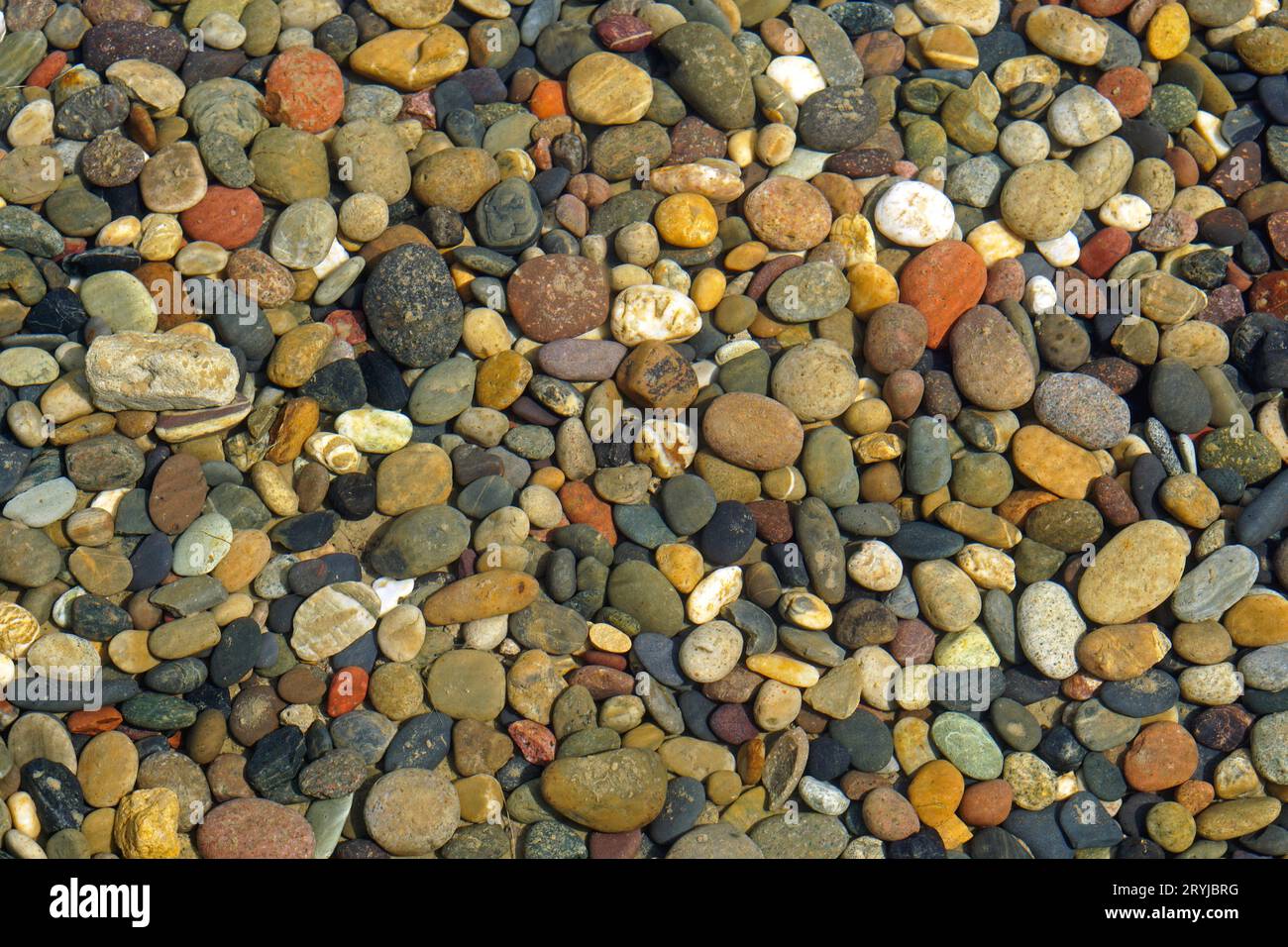 Color pebbles stones rocks under water at bottom Stock Photo - Alamy