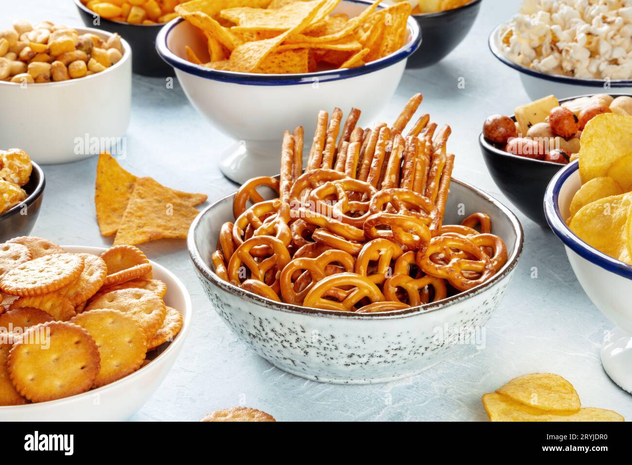 Salty snacks, party mix. An assortment of crispy appetizers in bowls ...