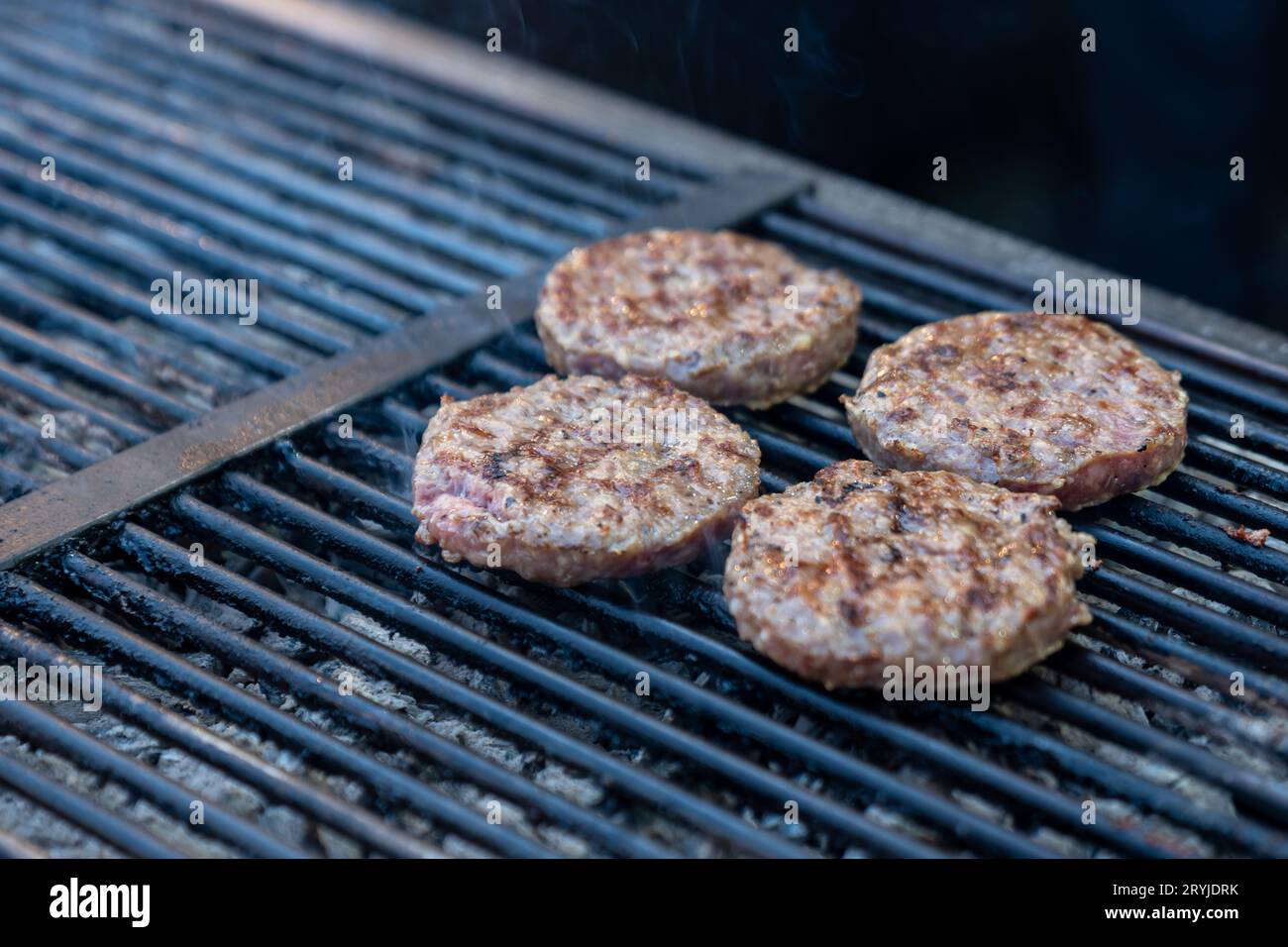 Chef making burger meat at the open air restaurant grill. Festival food ...