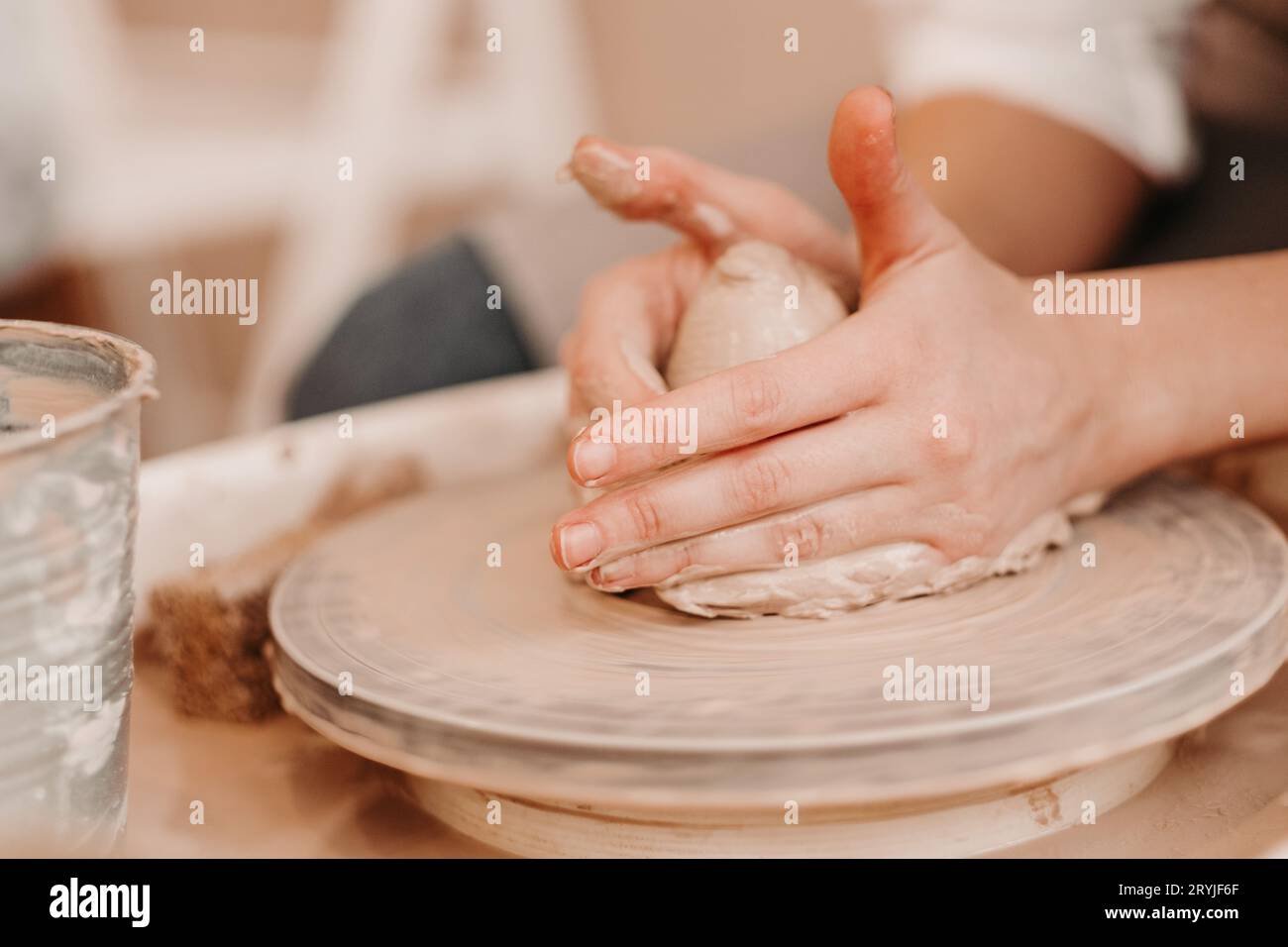 modeling on a potter's wheel. Hands are molded from clay. Creative ...