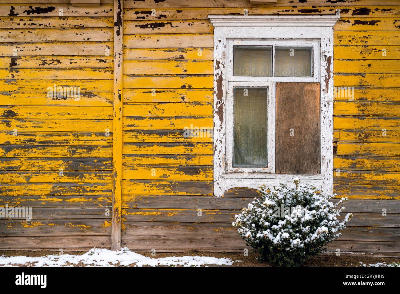 Old wooden yellow house with old window Stock Photo - Alamy