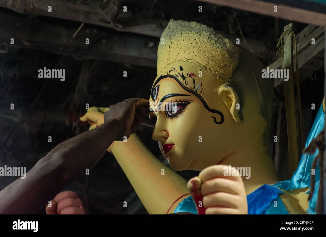 An artisan drawing eyes of idol of goddess Durga at Kumartuli, Kolkata ...