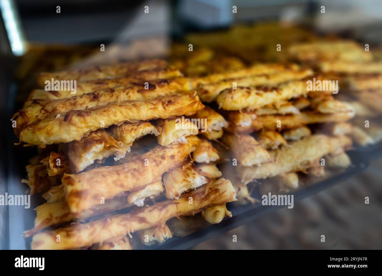Puff pastry pie on display in a store window. Burek Stock Photo - Alamy