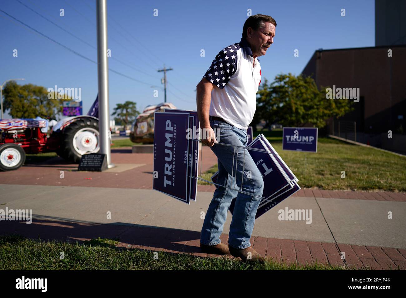 Gary Leffler carries yard signs for former President Donald Trump ...