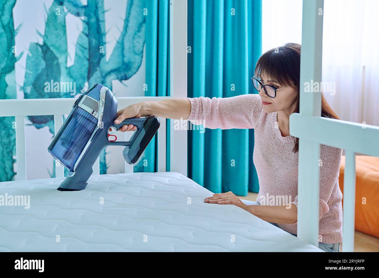 Woman doing house cleaning with vacuum cleaner Stock Photo - Alamy