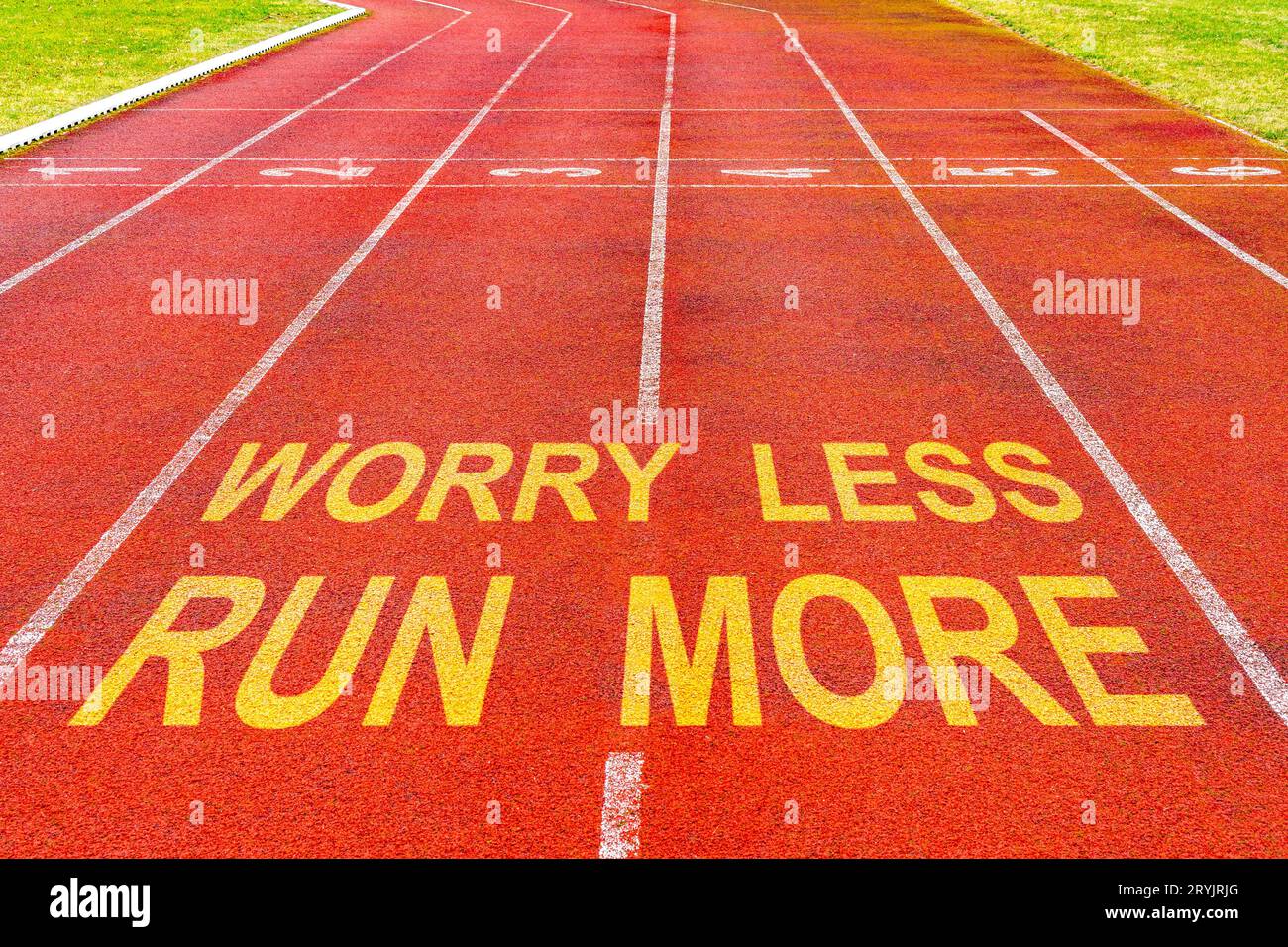 Worry Less Run More written on rubberized running track. Motivational ...