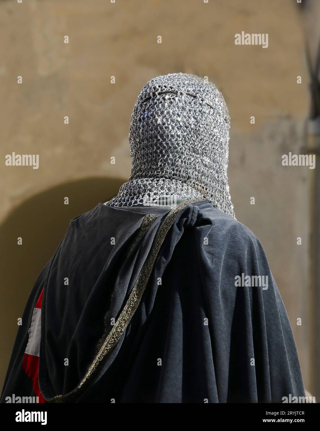 medieval knight with black clothes and metal protection on the head called chain mail Stock ...