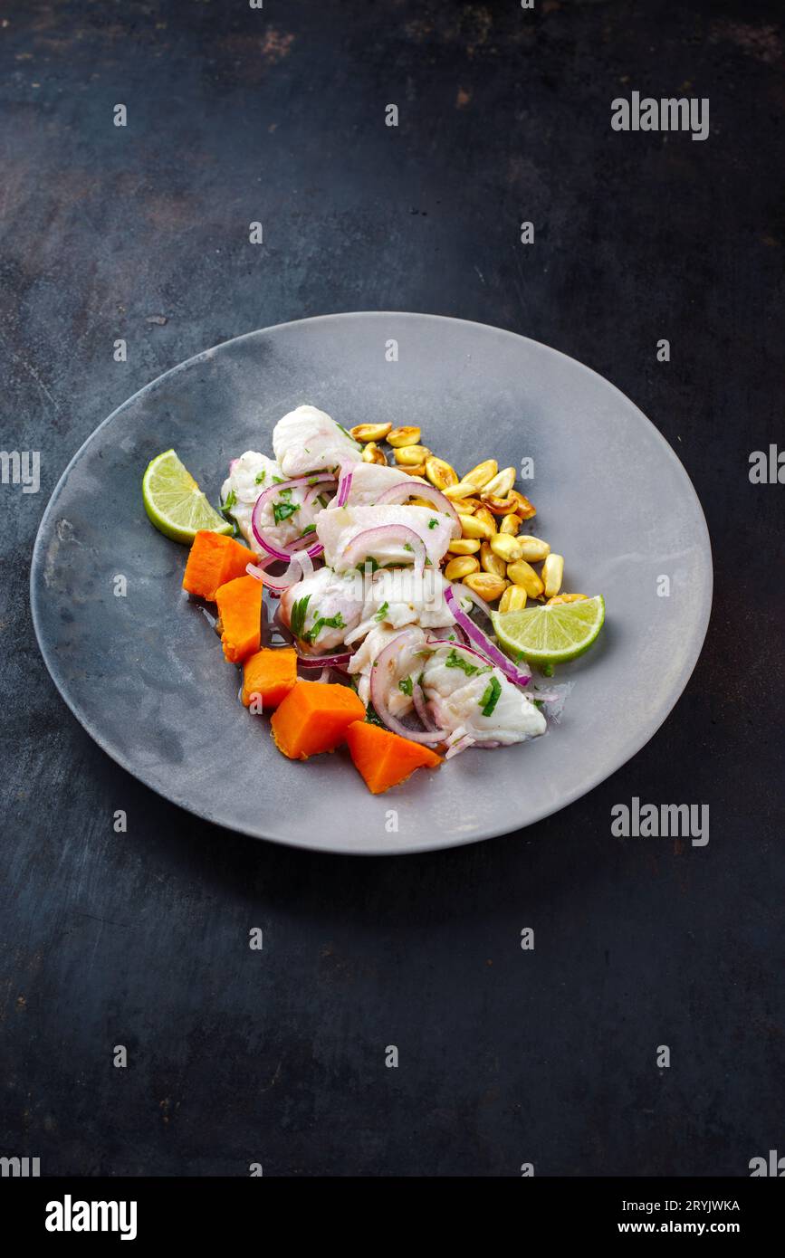 Traditional Peruvian gourmet ceviche sea bass filet piece with sweet ...
