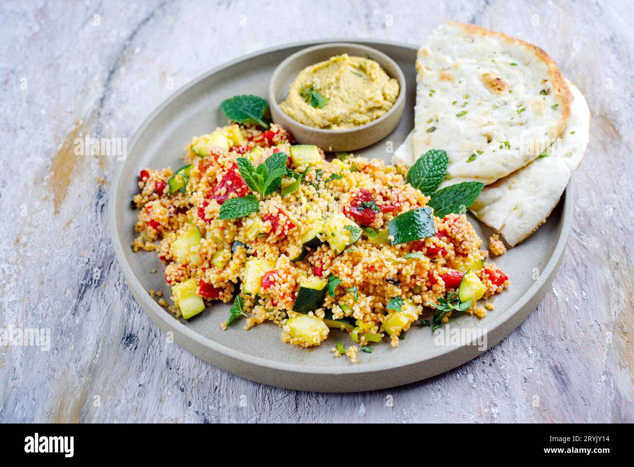 Traditional Moroccan vegetable couscous with pita bread and hummus ...