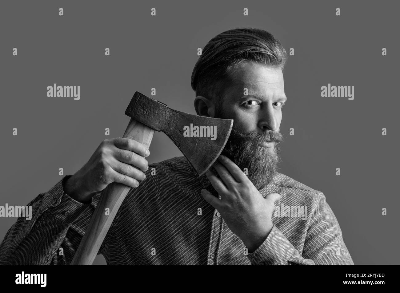 studio shot of red beard barber man holding axe blade. barber concept ...