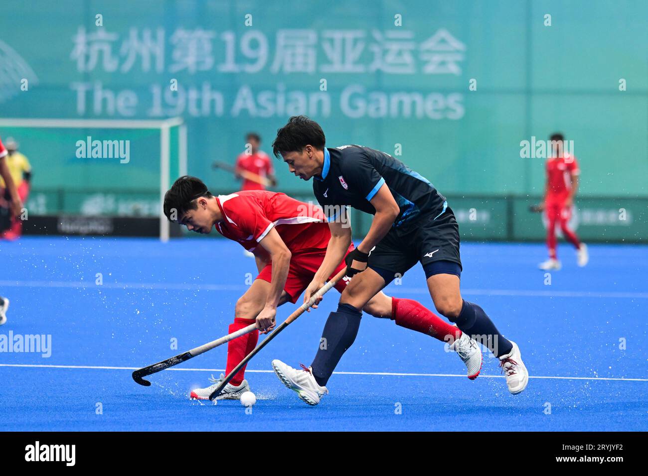Hangzhou, China. 30th Sep, 2023. Ethan Yi Hao Tan (L) of the Singapore men hockey team and ...