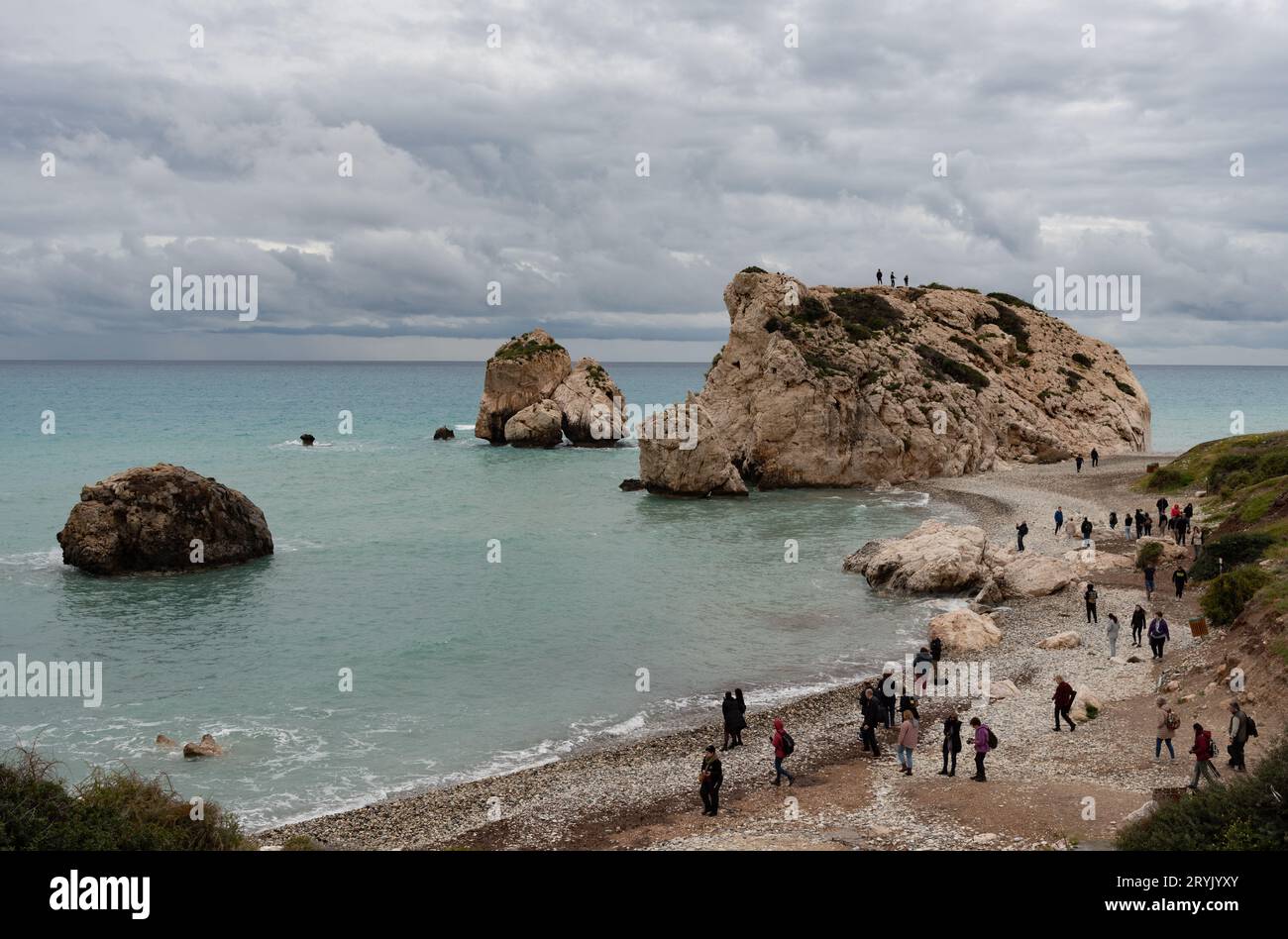 Tourists people at rocky coast landmark of Rock of Aphrodite beach at ...