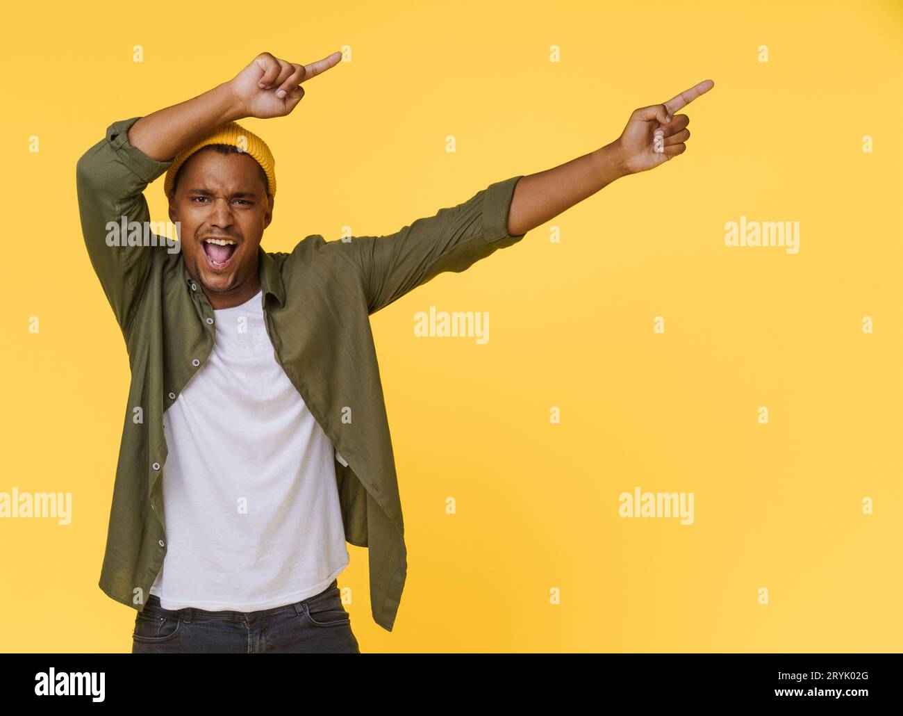 Excited African man points two hands to the side to copy space on ...