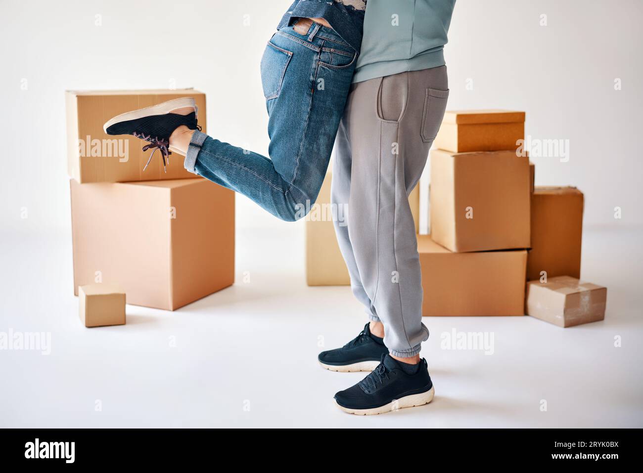 Husband lift wife surrounded by cardboard boxes excited to move in new ...