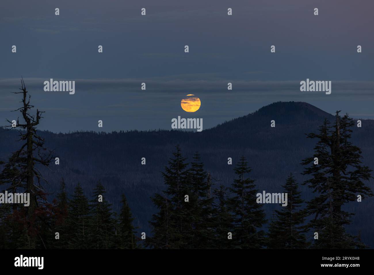 Close up of the harvest supermoon rising over the cascade mountains in ...