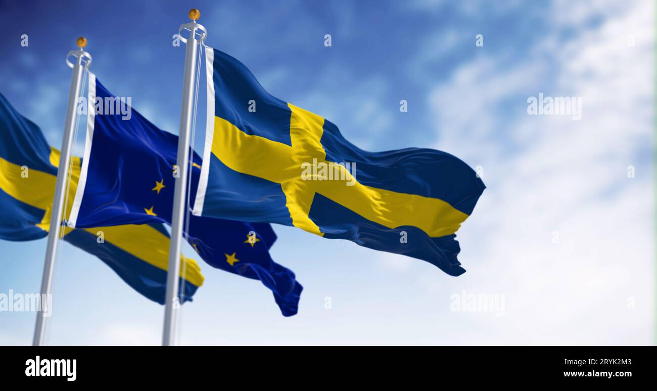 The flags of Sweden and the European Union waving together on a clear ...