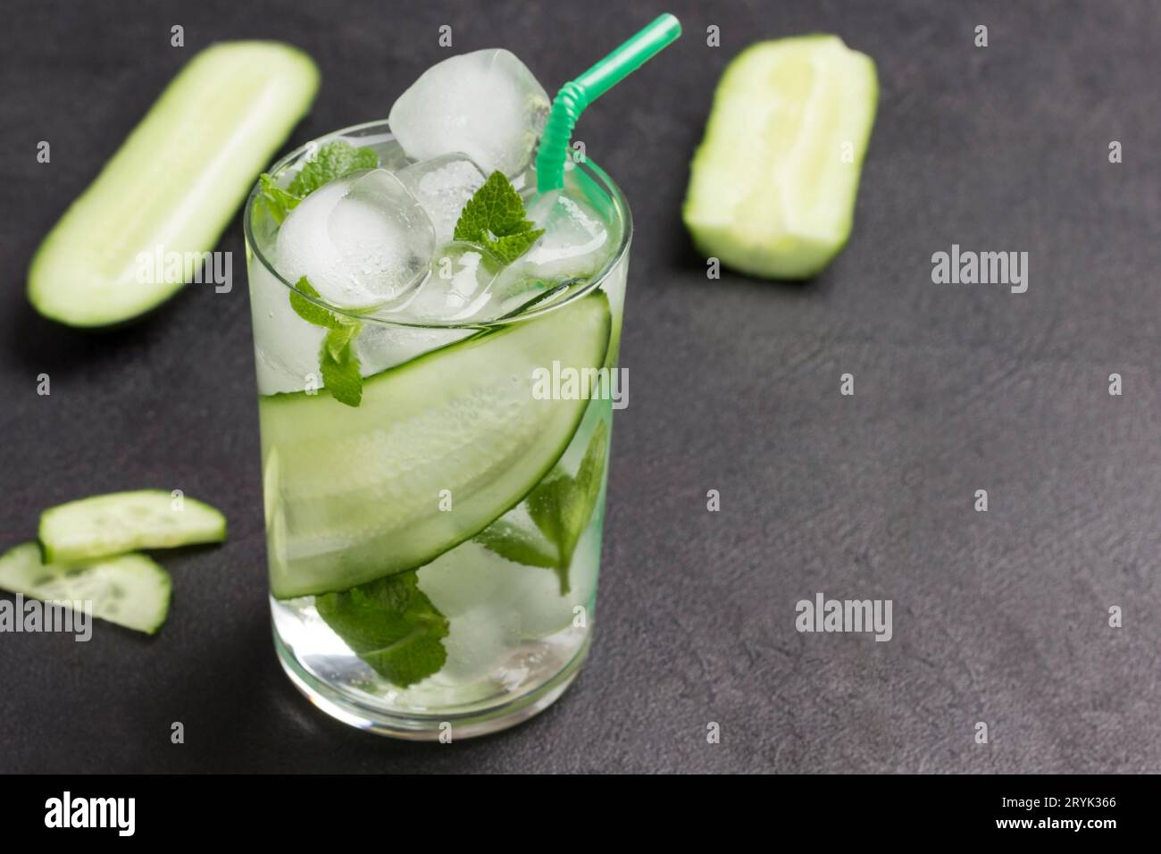 Cooling summer drink with ice and slices of cucumber. Mint and chopped ...