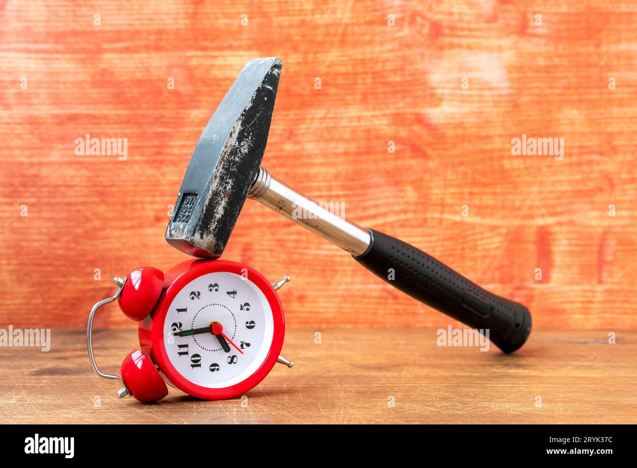 Hammer breaking classic alarm clock Stock Photo - Alamy