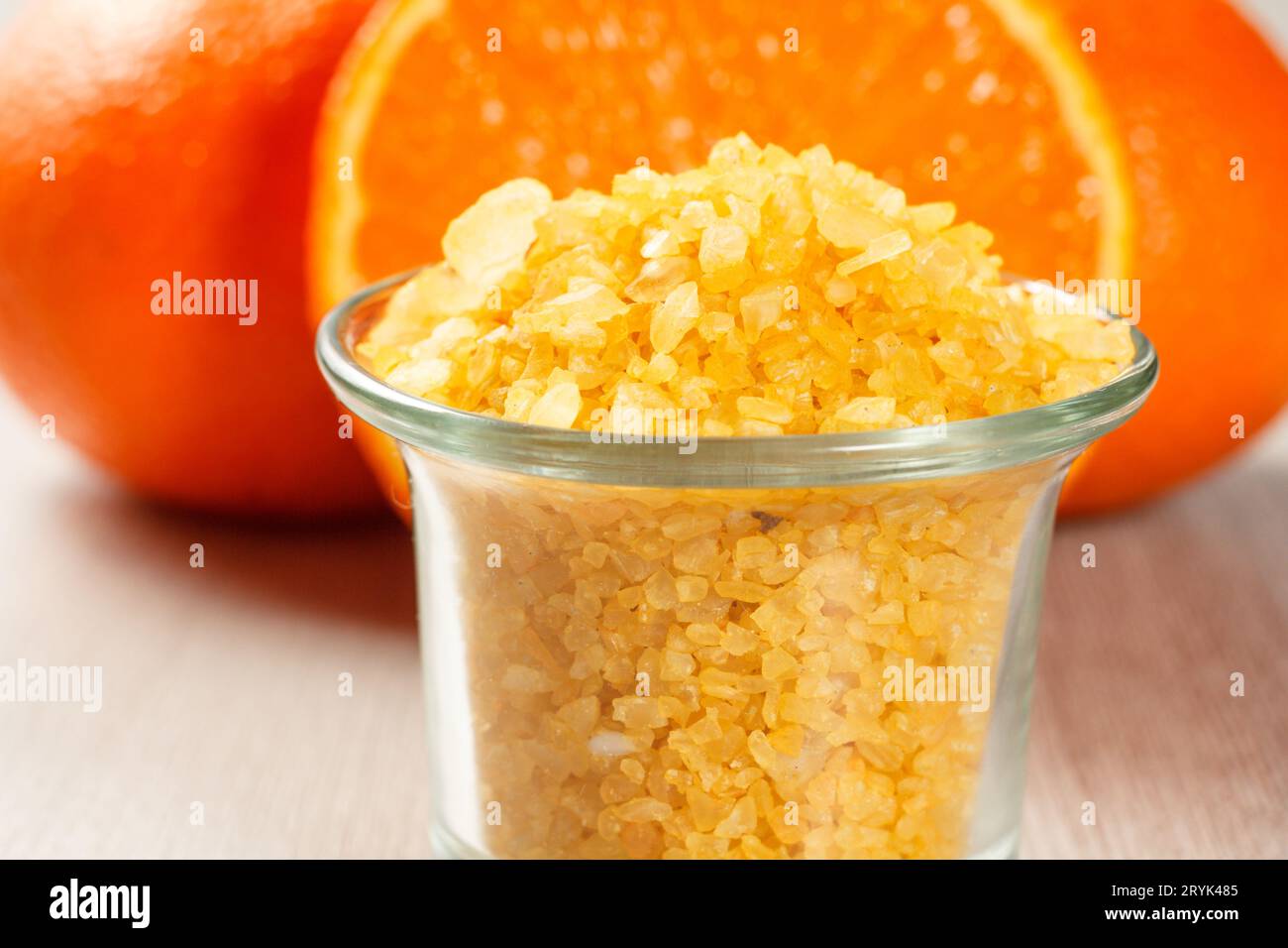 Cut orange and the glass bowl with yellow sea salt Stock Photo - Alamy