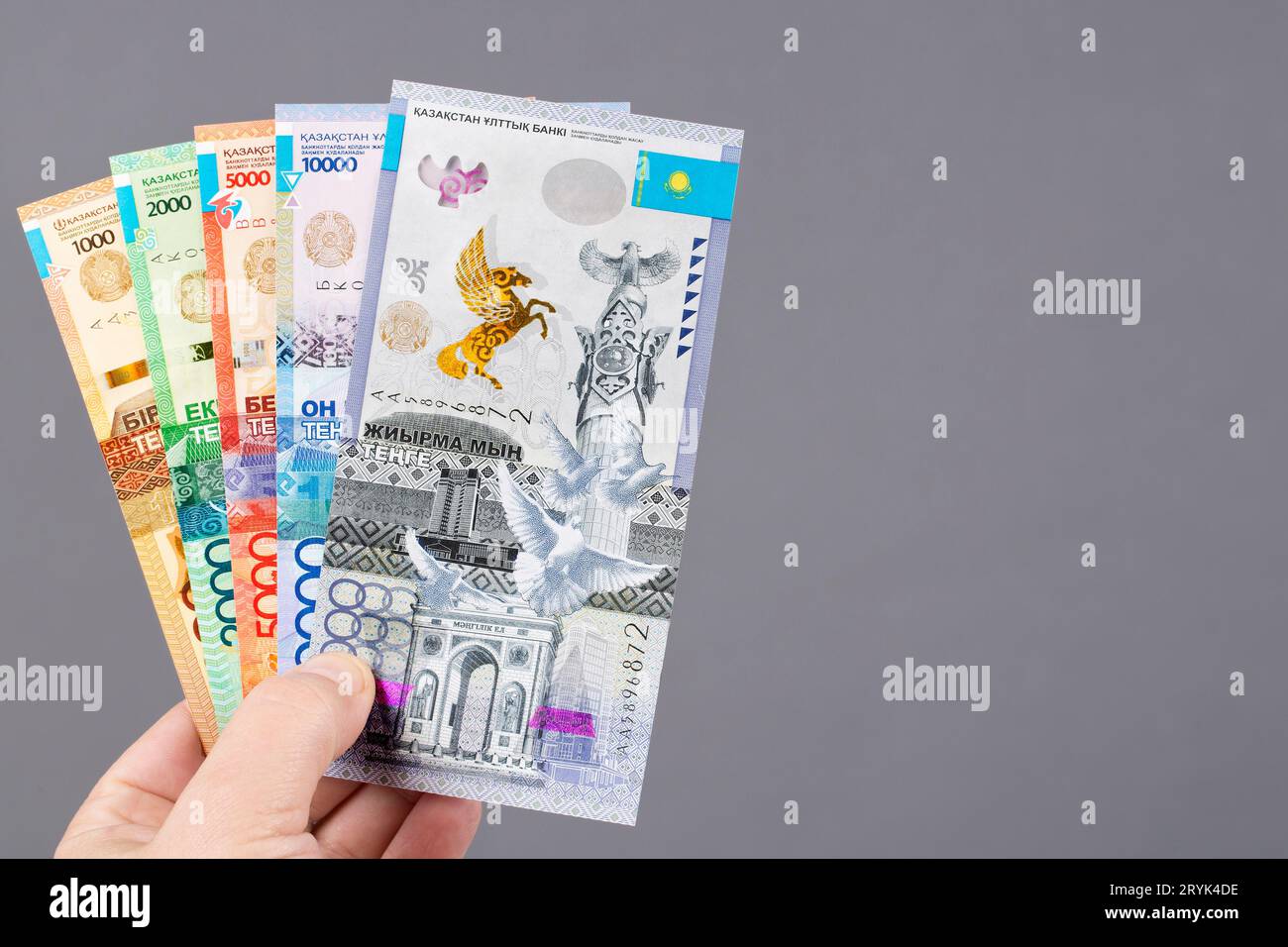 Kazakh money in the hand Stock Photo - Alamy