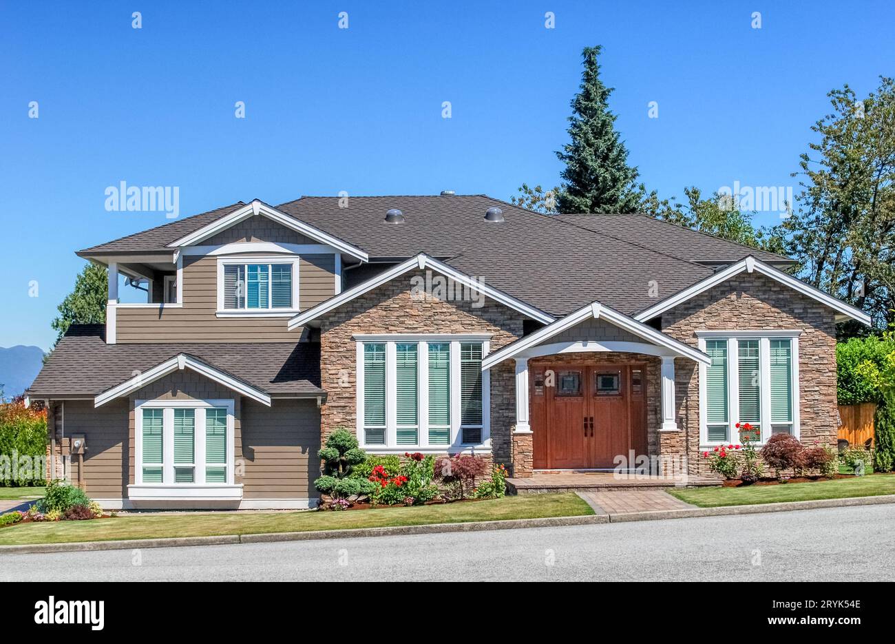 Luxury residential house with landscaped front yard and pawed pathway ...