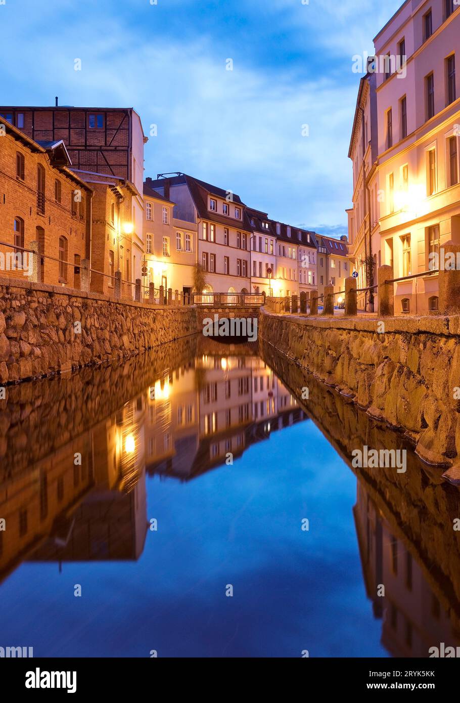 Hanseatic houses in the evening are reflected in the pit, an artificial ...