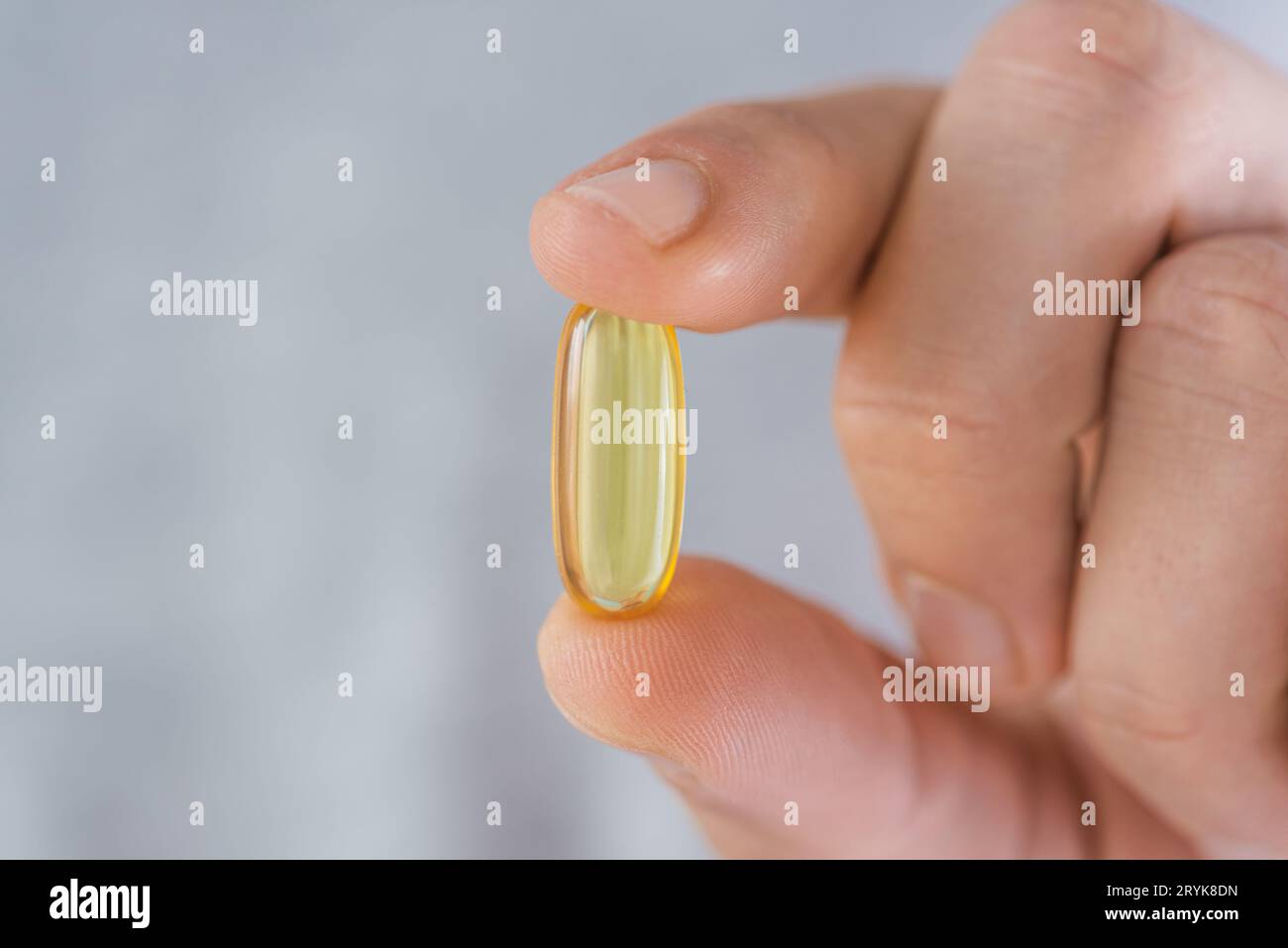 Man holding capsules with omega 3, vitamin D in hand. Nutritional ...