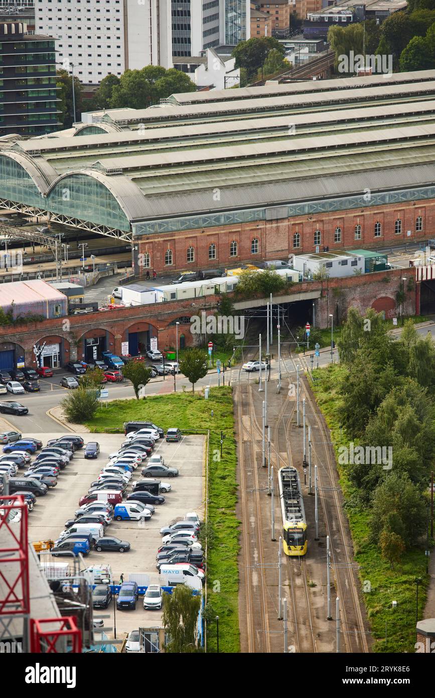 Rooftop view, looking down on Manchester Piccadilly with a Metrolink ...