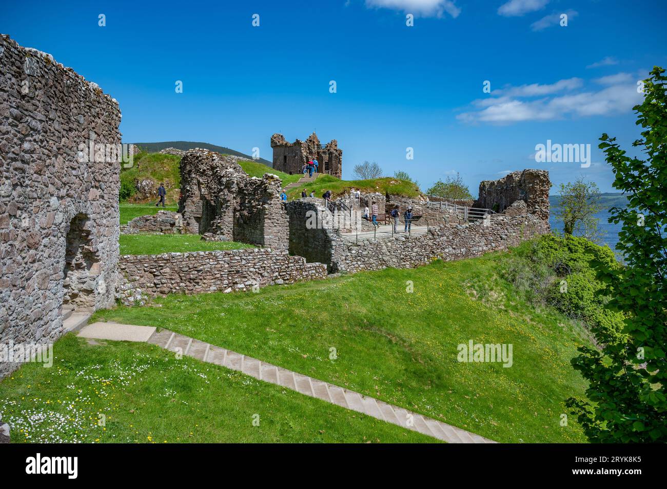 Urquhart Castle with tourist walking around, Loch ness lake in the ...