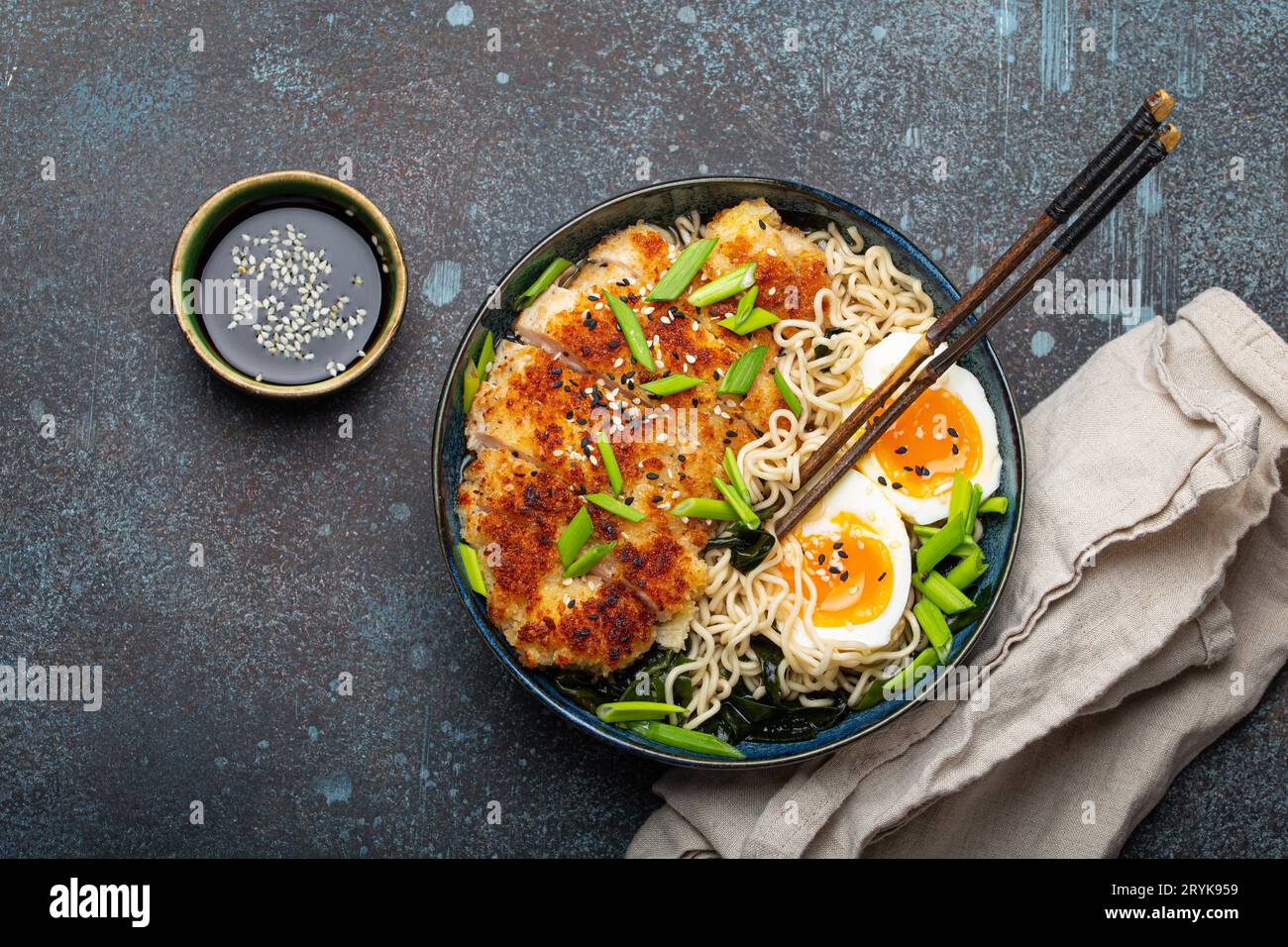 Asian noodles ramen soup with deep fried panko chicken fillet and ...