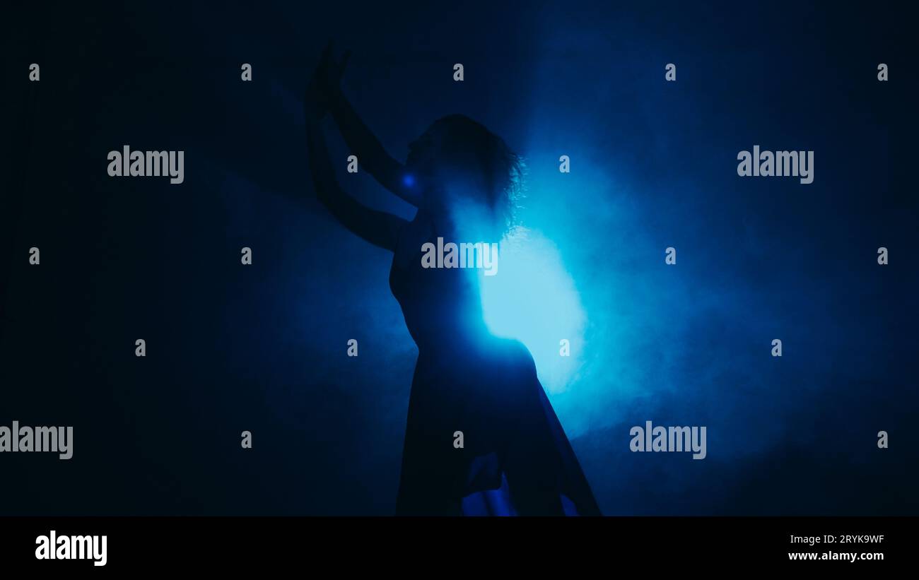 Body performance woman dancing steam spot light Stock Photo - Alamy