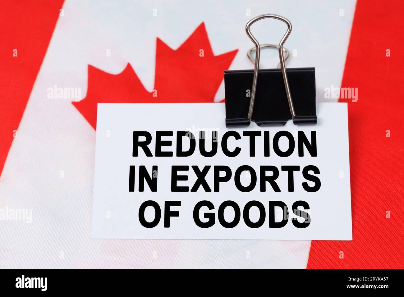 Economy and finance concept. On the flag of Canada lies a business card ...