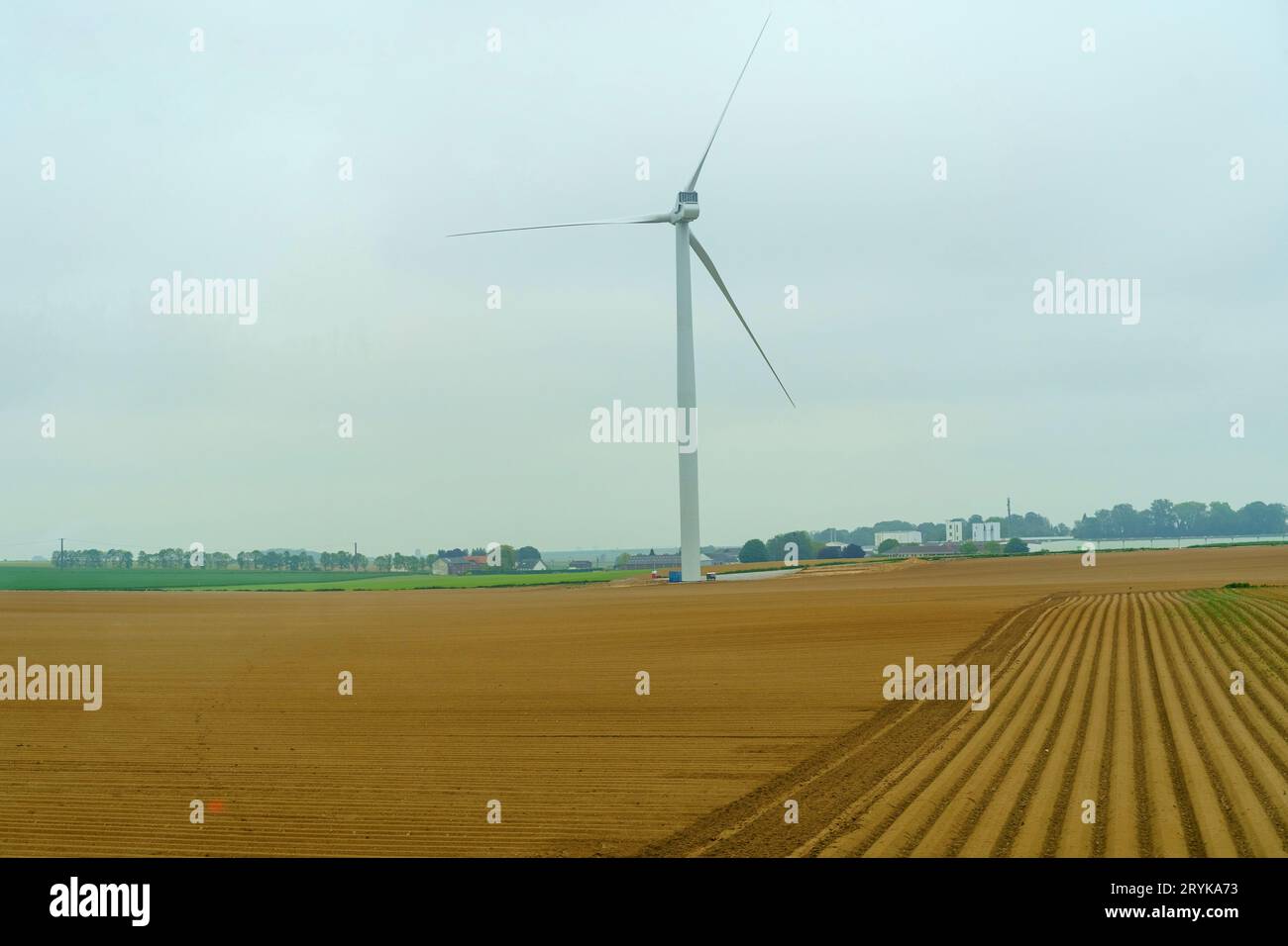 Wind turbines to generate electricity in plowed agricultural fields ...