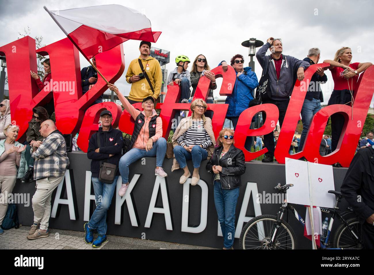 People hold anti-Law and Justice placards and wave Polish flags during ...