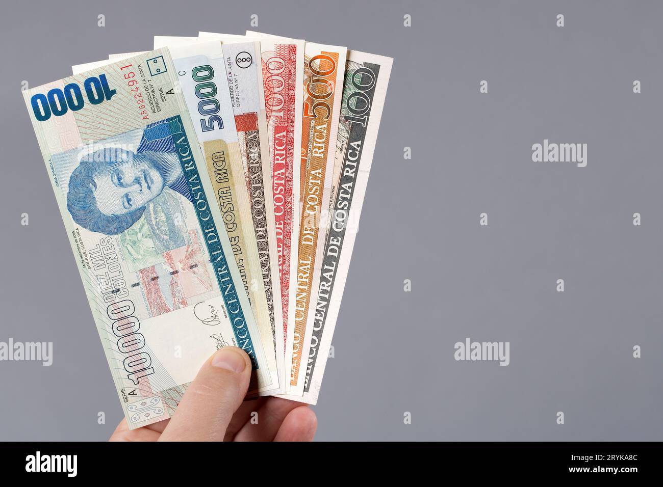 Costa Rican money - Colones in the hand on a gray background Stock ...
