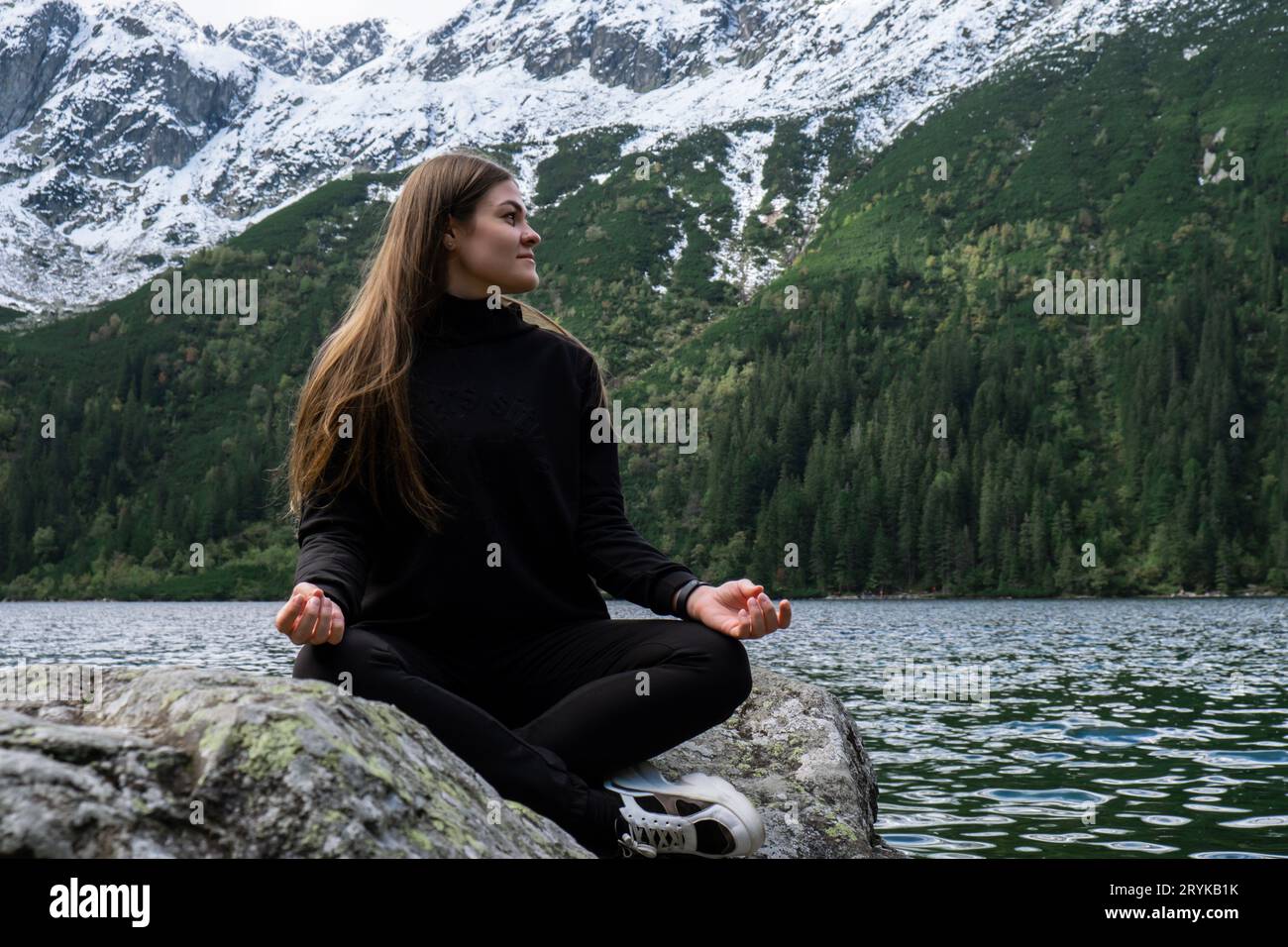 Young woman enjoying nature in Morskie Oko Snowy Mountain Hut in Polish ...
