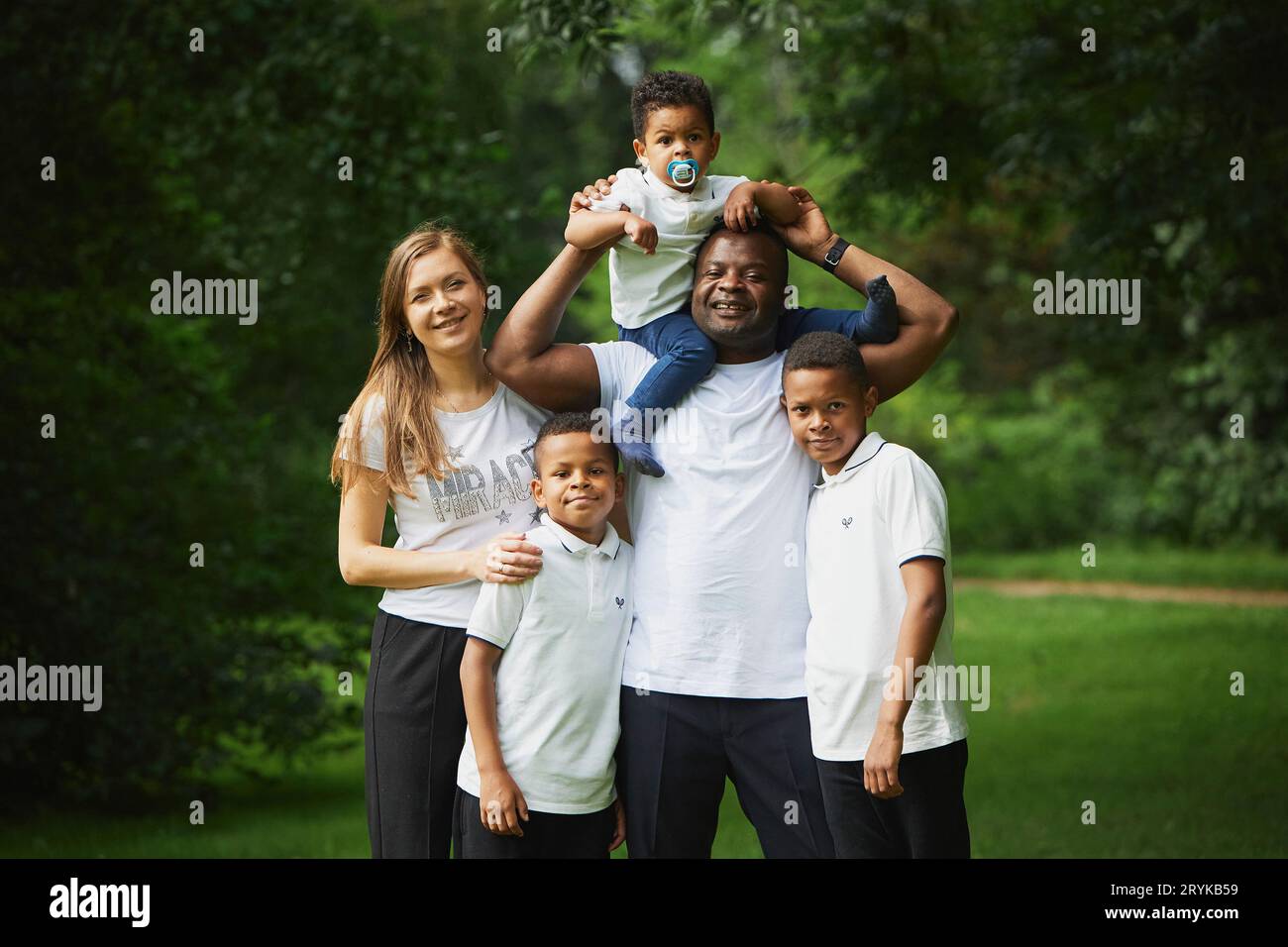 Tilst, Denmark, 12th of August, 2023: Interracial family in the forest ...