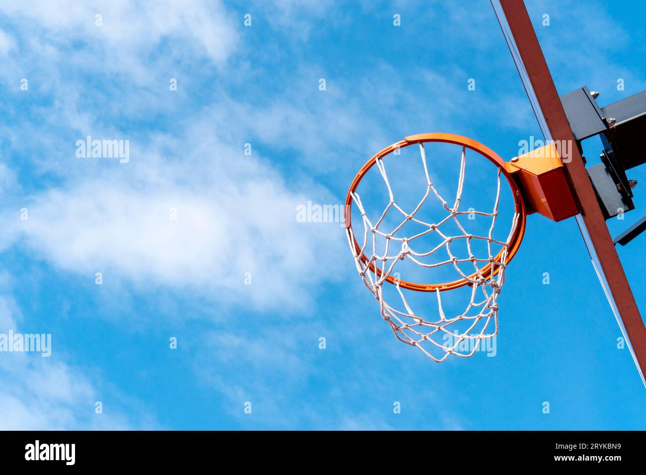 Basketball hoop against a blue sky from a low angle Stock Photo - Alamy