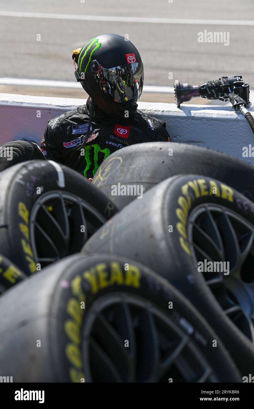 A crew member of NASCAR Cup Series driver Ty Gibbs (54) takes a break ...