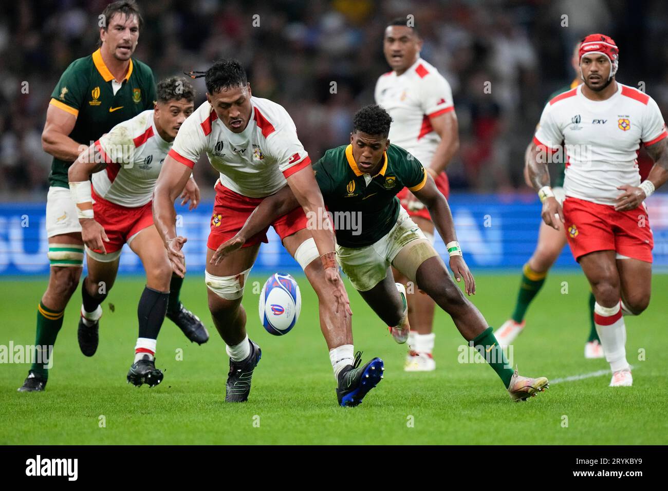 Tonga's Sam Lousi, left, challenges for the ball with South Africa's ...