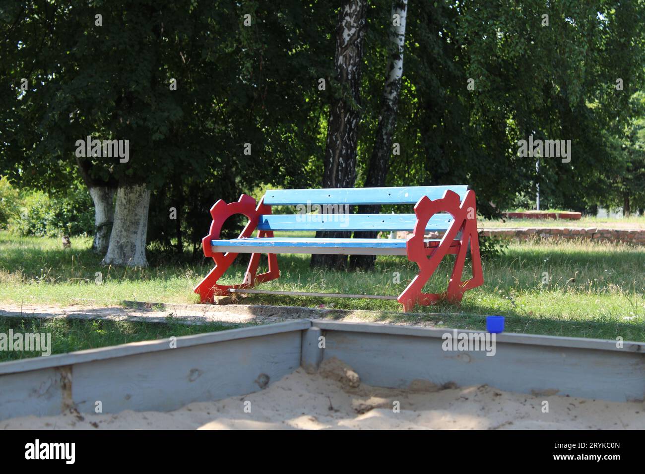 A park bench in the green recreation area. A place to relax near trees ...
