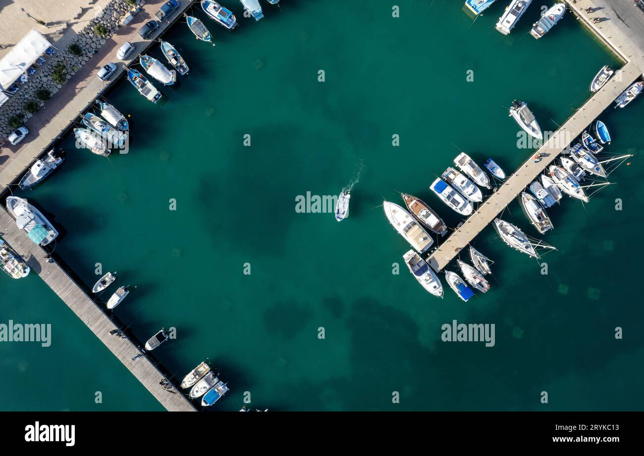 Drone aerial scenery of a fishing port. Fishing boats and yachts moored ...