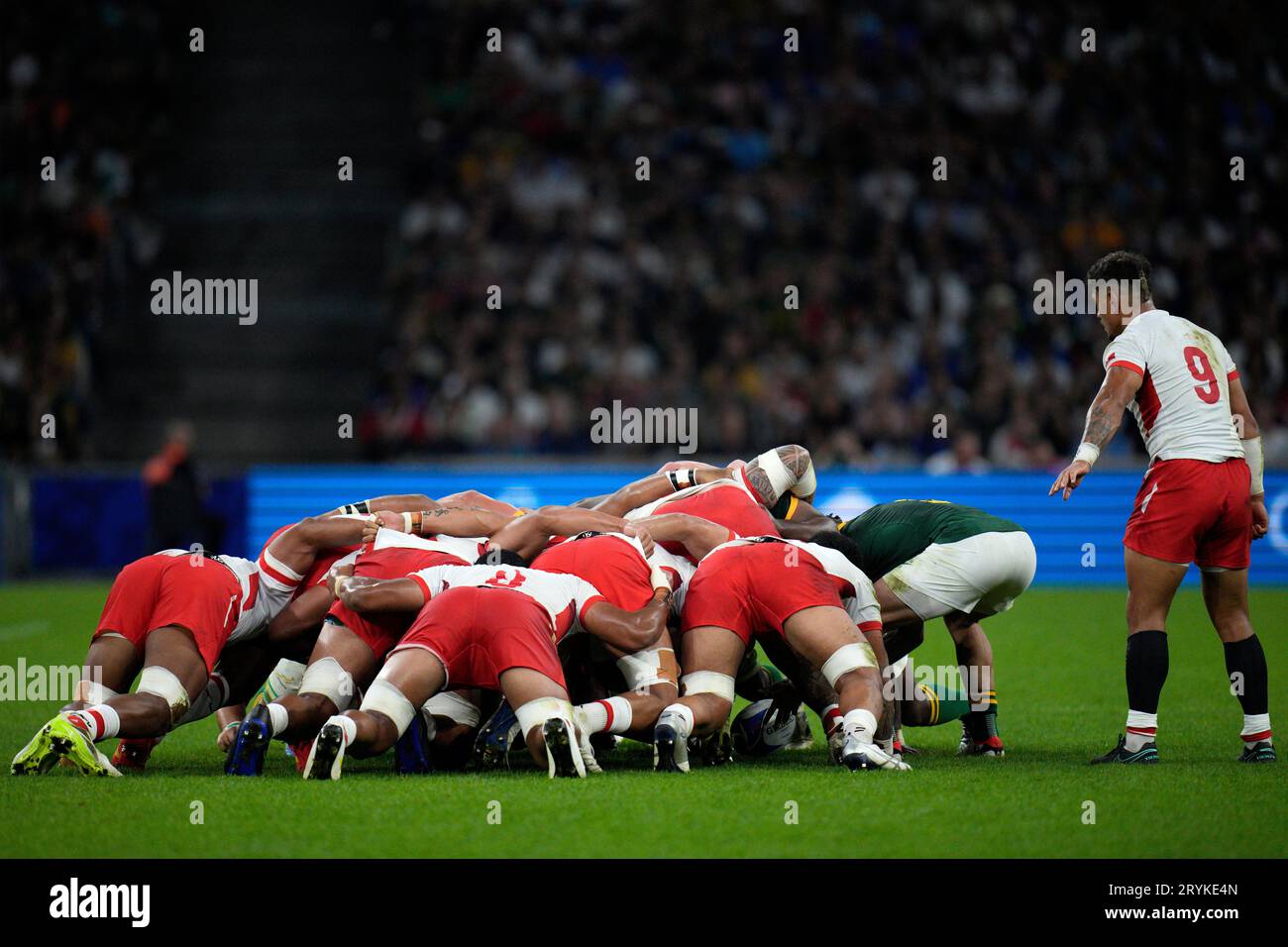 Tonga's Augustine Pulu looks on as his teammates contest a scrum during ...