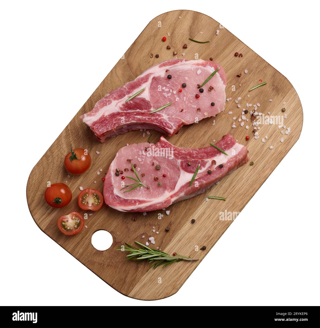 Raw pork tenderloin on the bone and spices on a wooden cutting board on ...