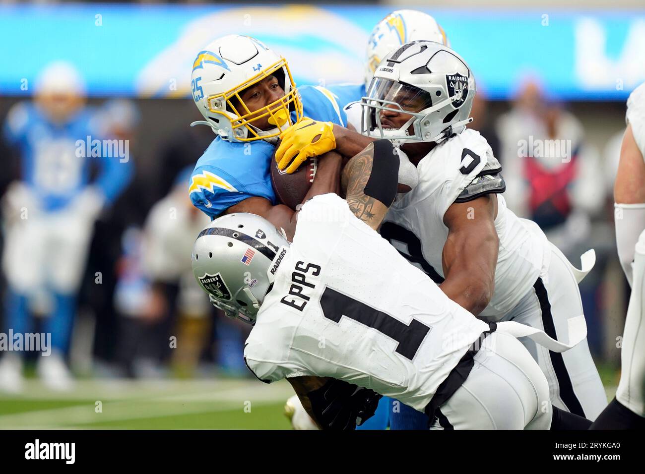 Los Angeles Chargers running back Joshua Kelley, left, is tackled by ...