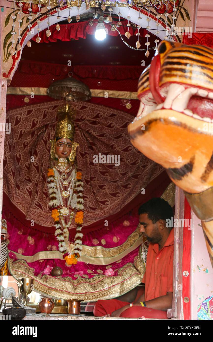 Jodhpur, Rajasthan, India - January 12, 2017: Indian Monk in orange dress praying in front of ...