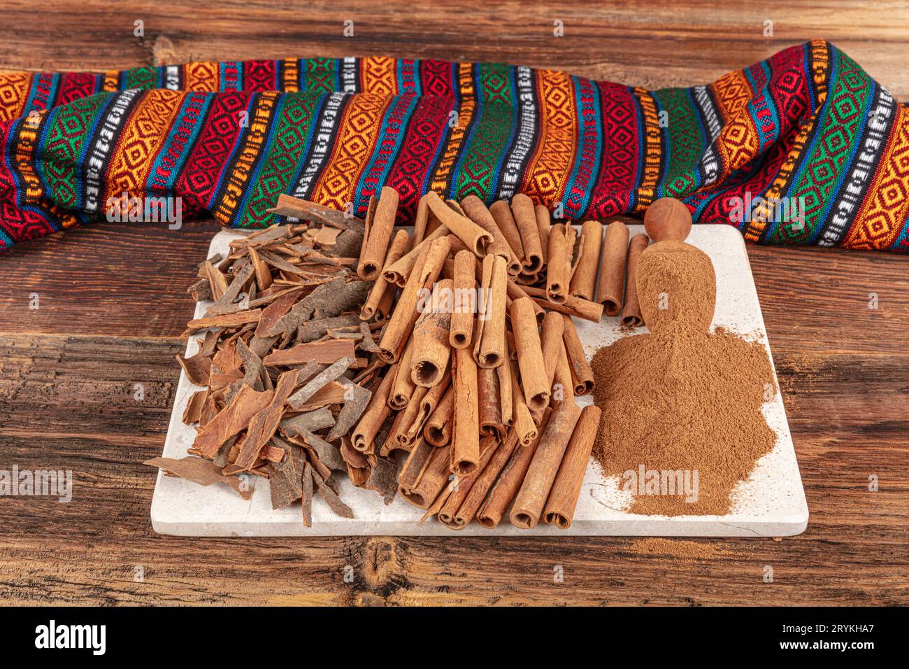 Cinnamon sticks on a wooden background. Cinnamon spice in a spoon and ...
