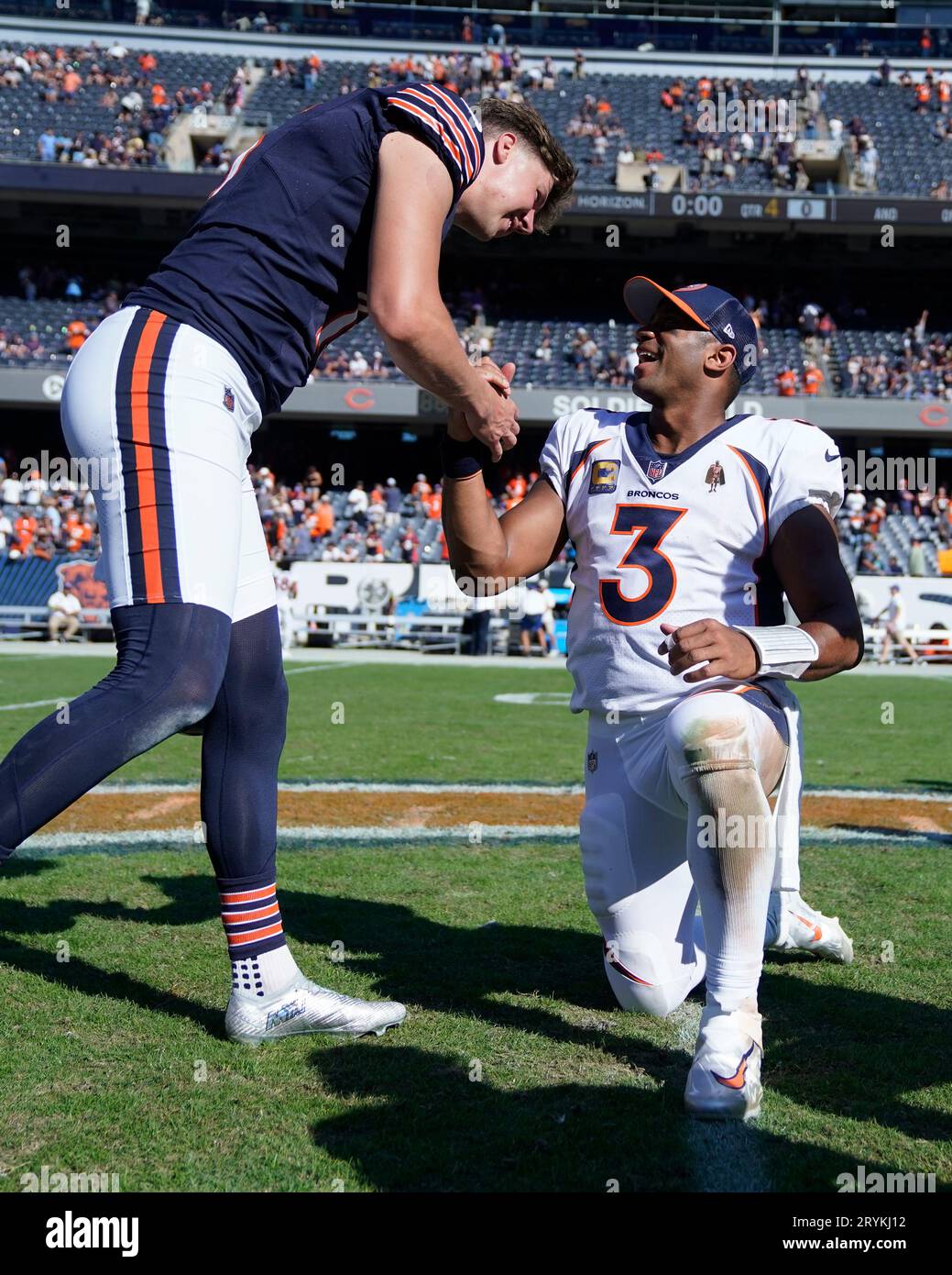 Chicago Bears punter Trenton Gill, left, congratulates Denver Broncos ...
