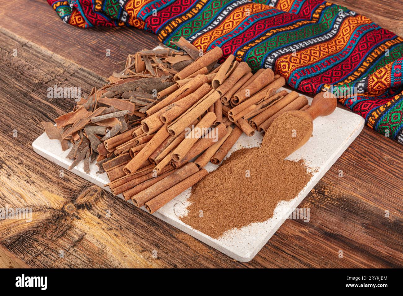 Cinnamon sticks on a wooden background. Cinnamon spice in a spoon and ...